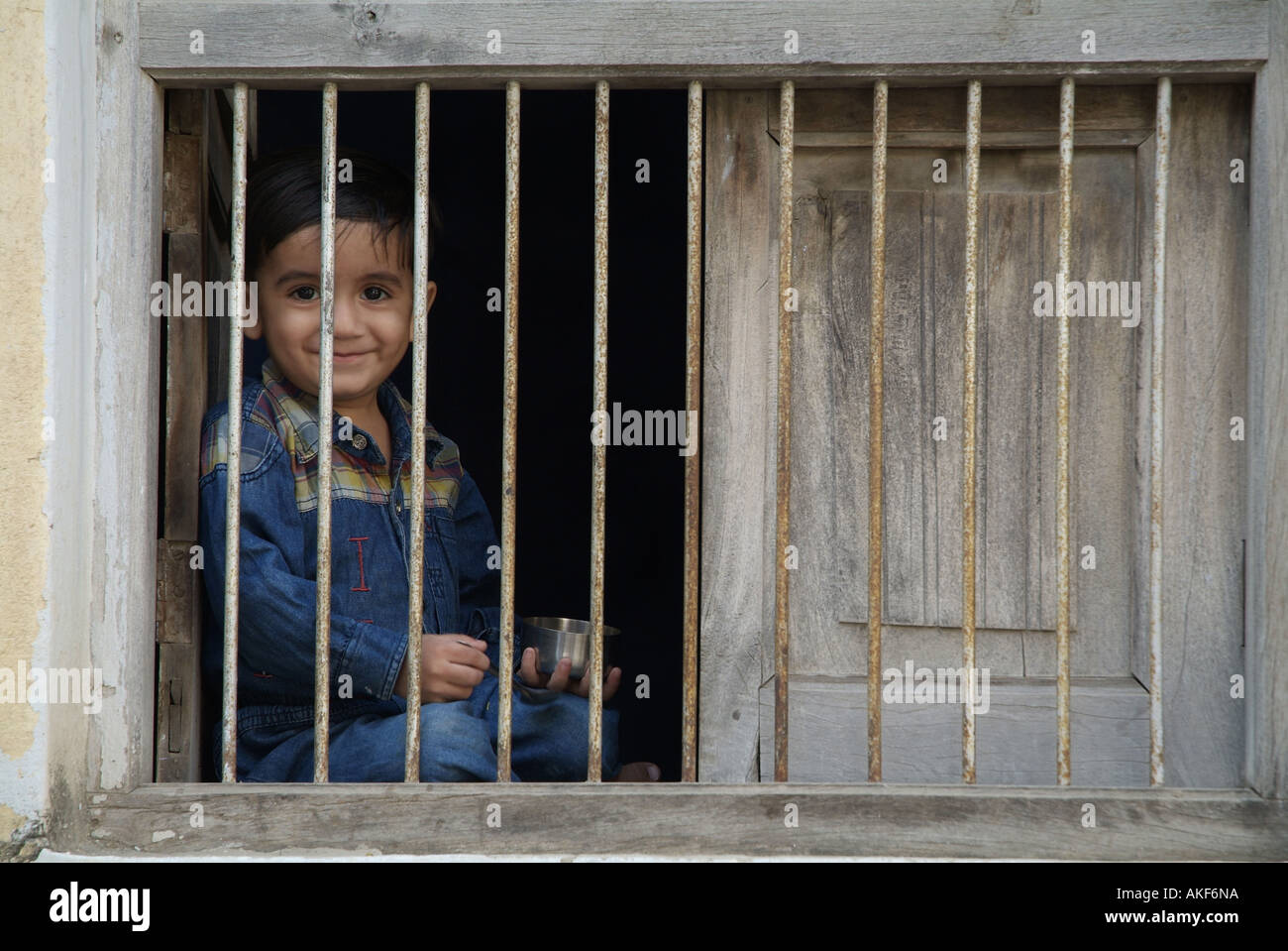 Boy looking out a barred window, Rajasthan, India Stock Photo - Alamy