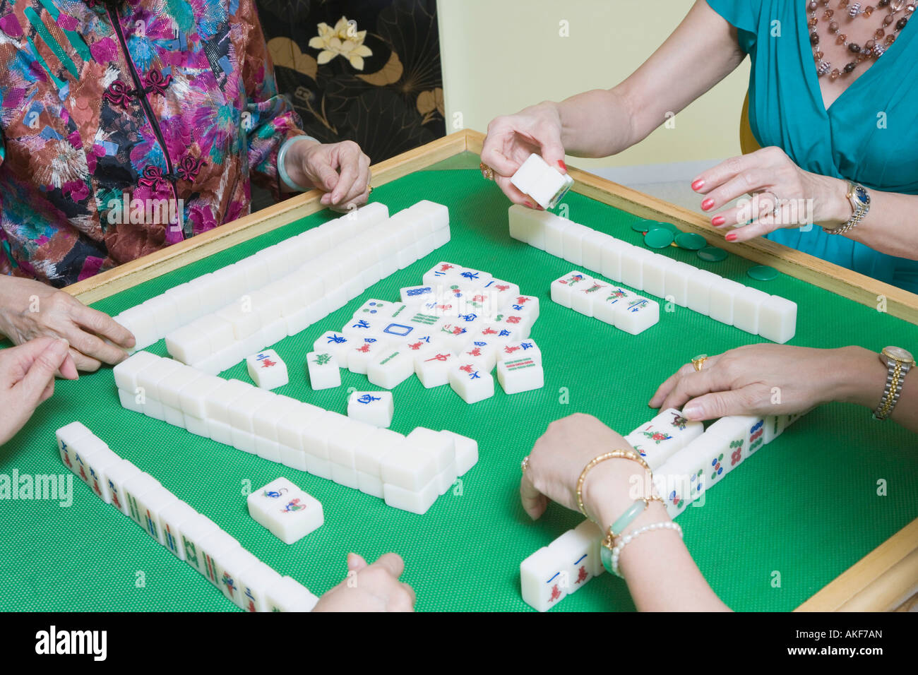Four women playing mahjong Stock Photo - Alamy