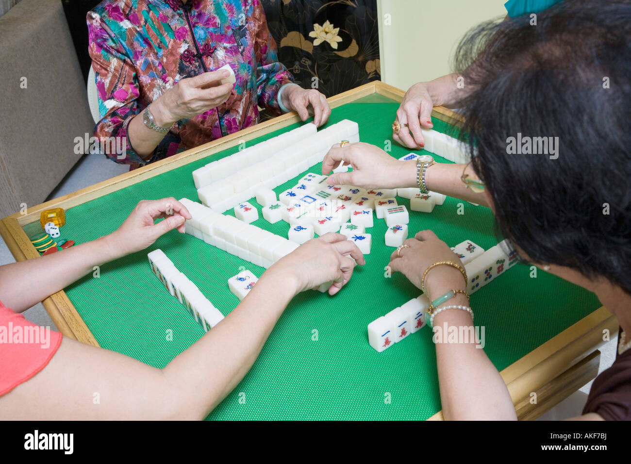 Four women playing mahjong Stock Photo - Alamy
