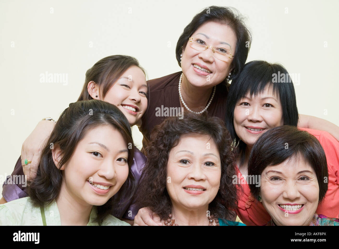 Portrait of a group of women posing and smiling Stock Photo - Alamy