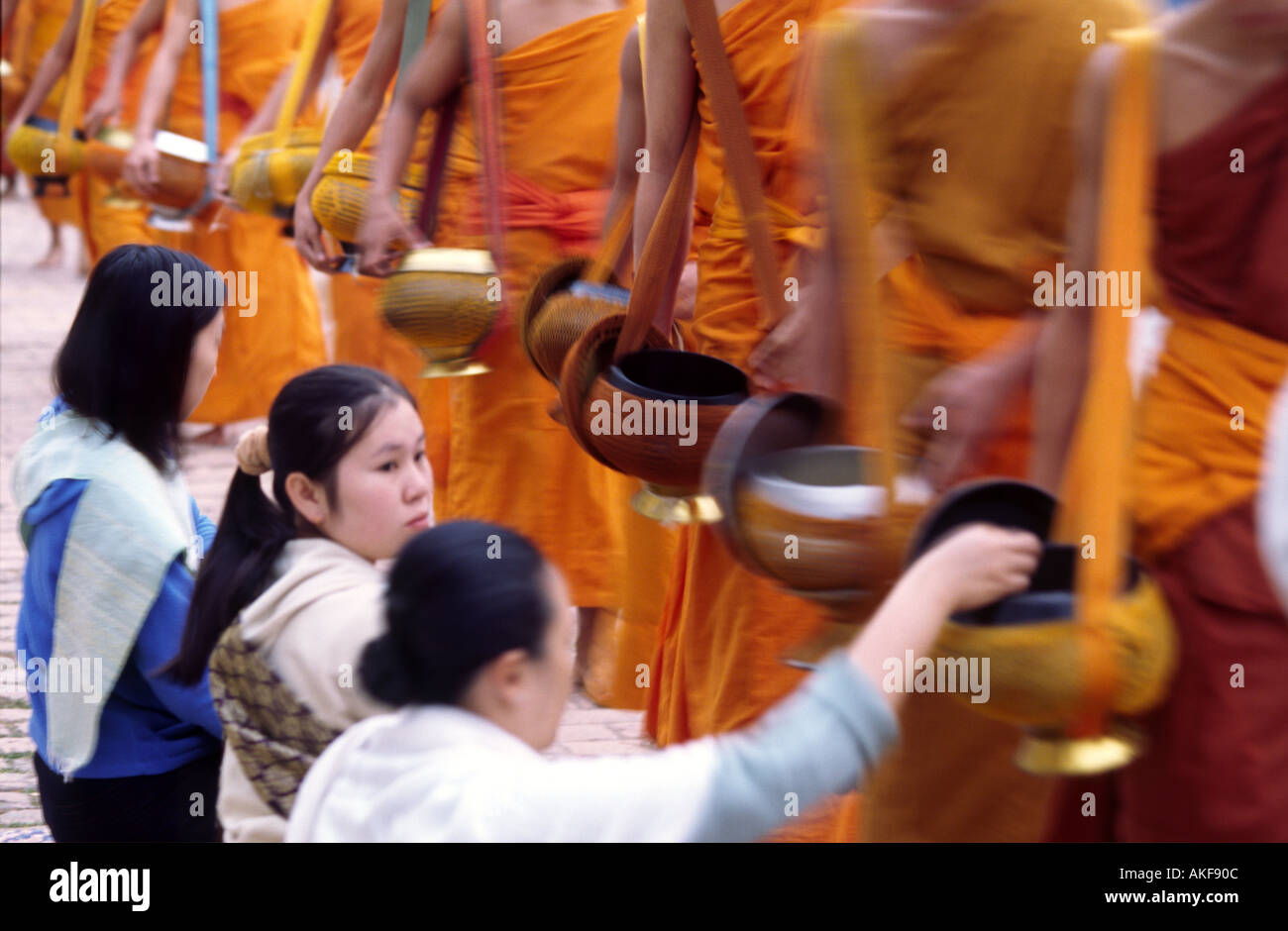 Buddhist monk receiving alms hi-res stock photography and images - Alamy