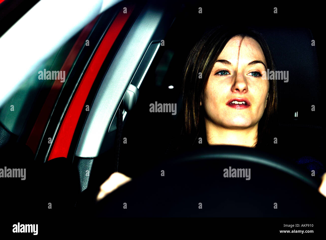 young woman driver through the windscreen red vw golf Stock Photo - Alamy