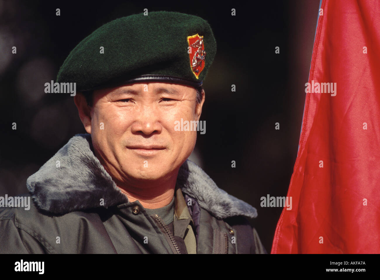 ethnic senior Vietnamese Vietnam Veteran man with full face and red ...