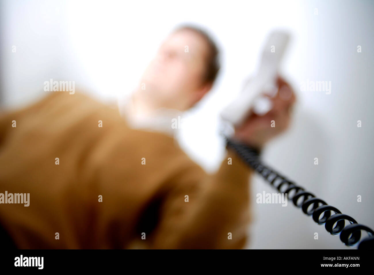Man making telephone call with focus on the telephone cable Stock Photo ...