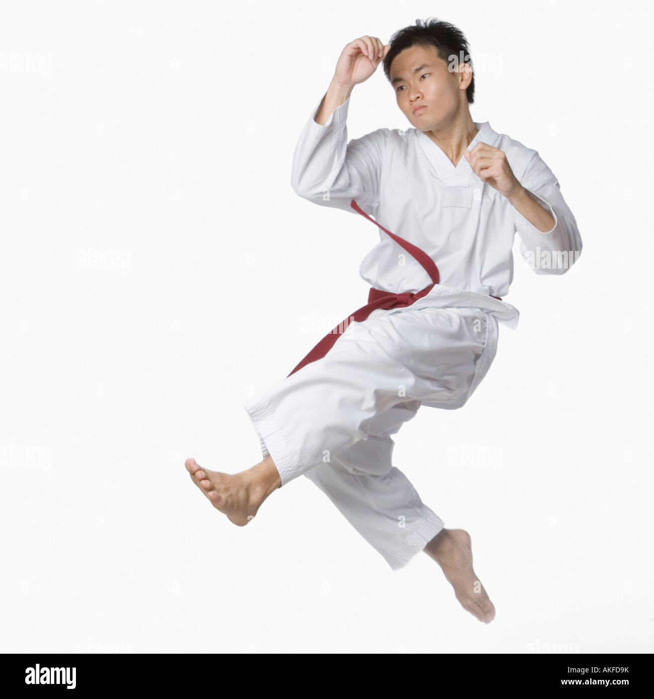 Young man posing in mid-air Stock Photo - Alamy