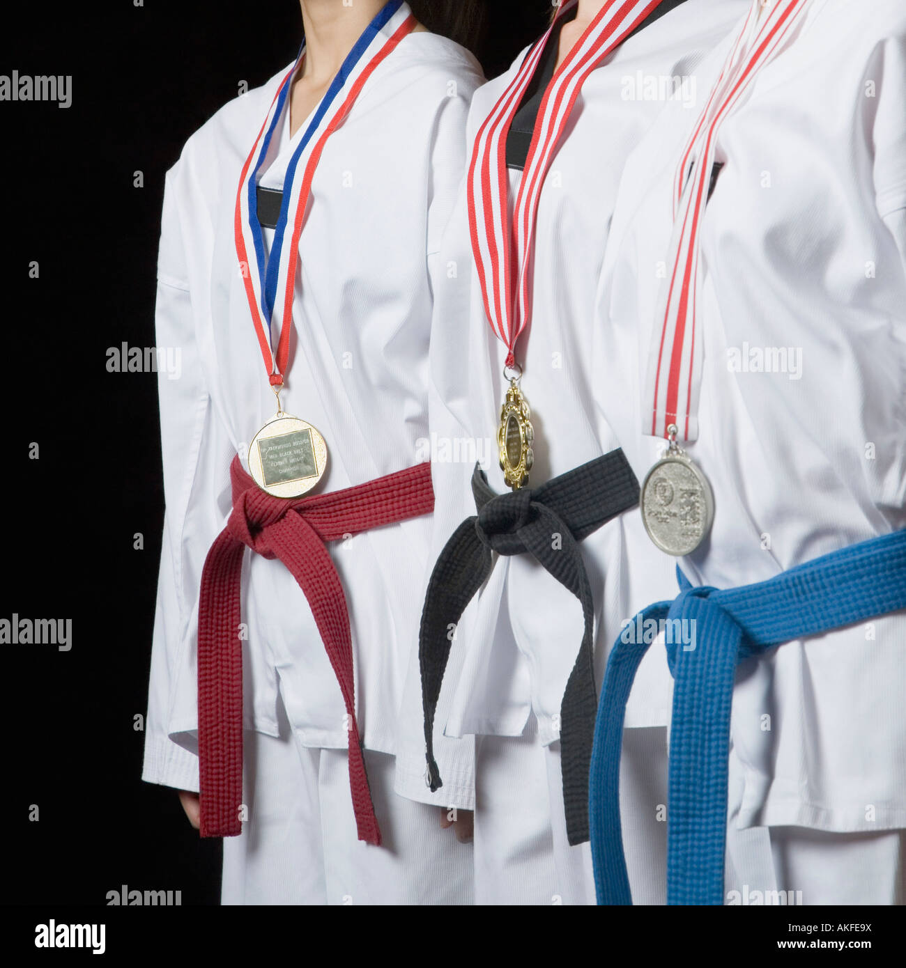 Mid section view of three people standing with their medals Stock Photo ...