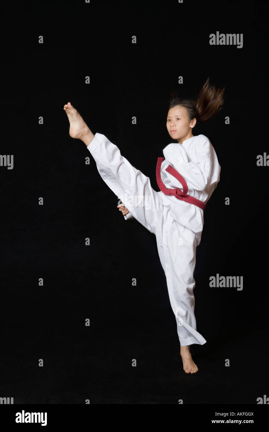 Young woman performing round kick Stock Photo - Alamy
