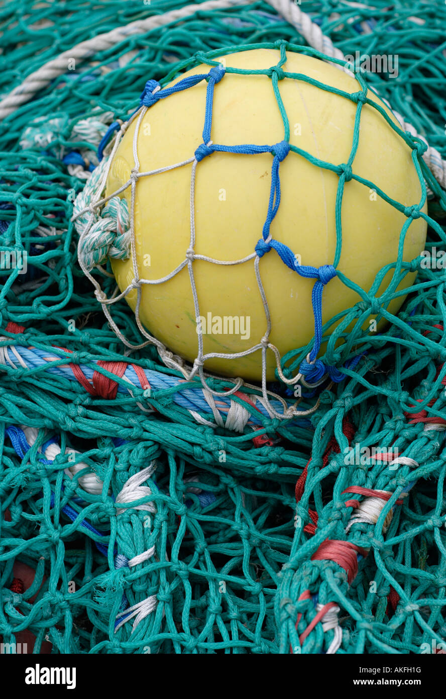Commercial fishing nets and yellow buoy Stock Photo - Alamy