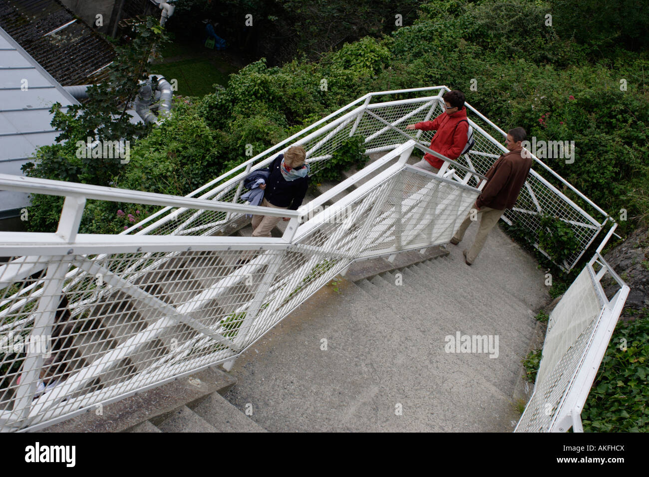 People descending a steep exterior staircase Stock Photo - Alamy