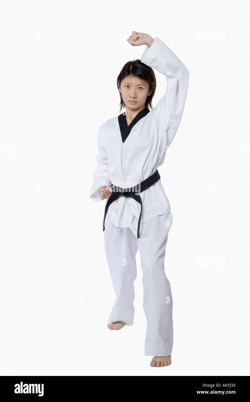 Young woman practicing upper block Stock Photo - Alamy