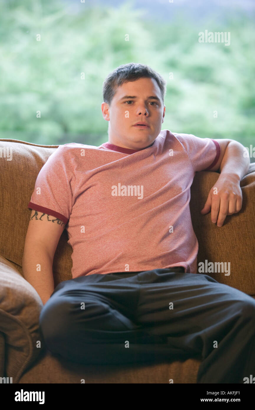 Man sitting on a sofa Stock Photo - Alamy