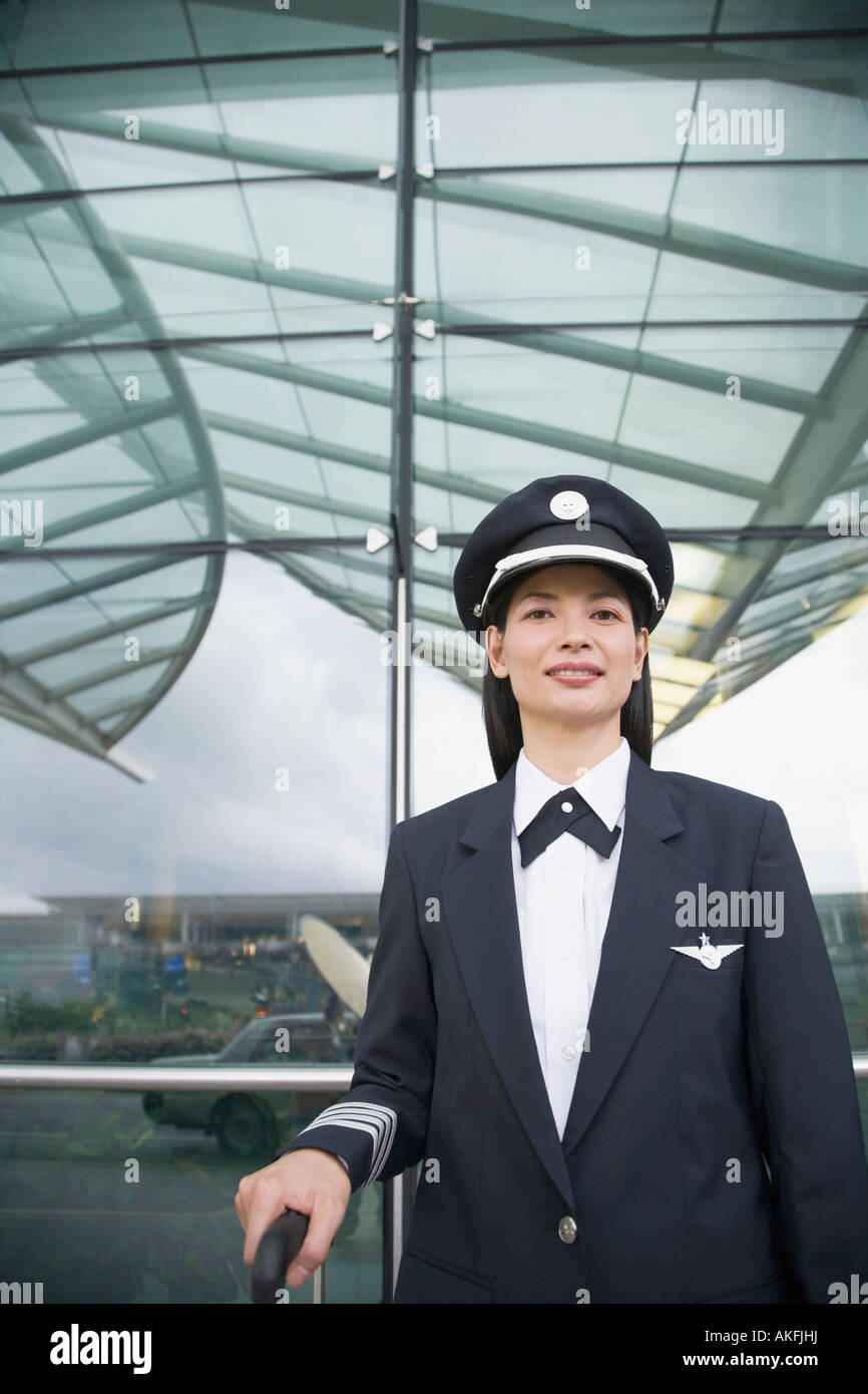 Portrait of a female pilot smiling Stock Photo - Alamy