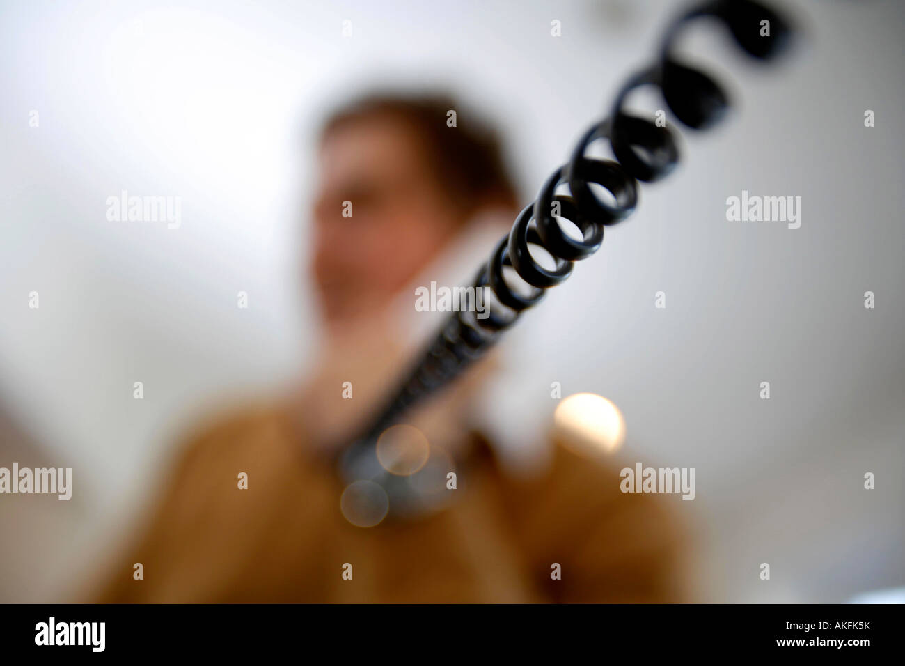 Man making telephone call with focus on the telephone cable Stock Photo ...