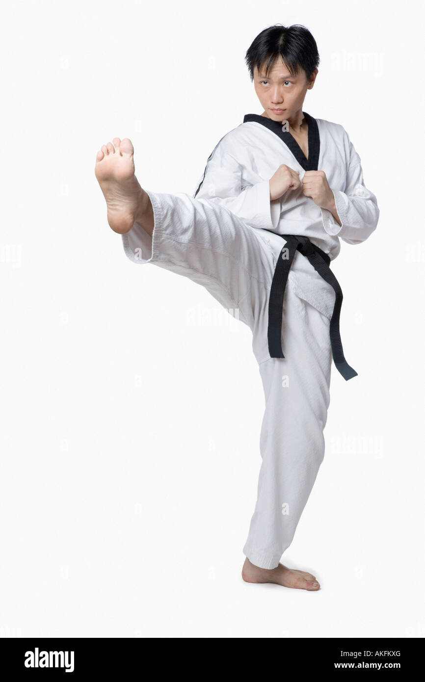 Mid adult man practicing front kick Stock Photo - Alamy