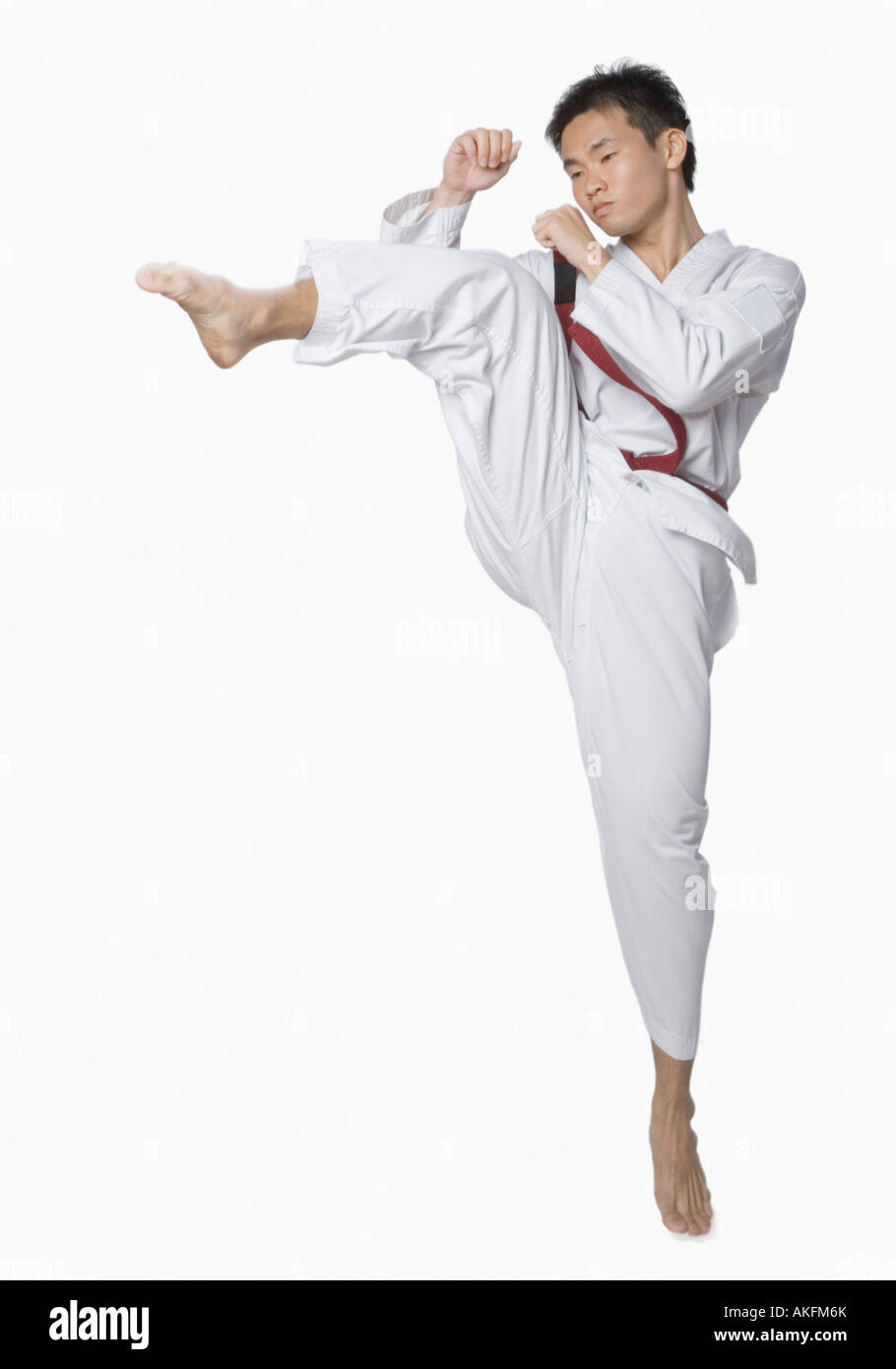 Young man kicking Stock Photo - Alamy