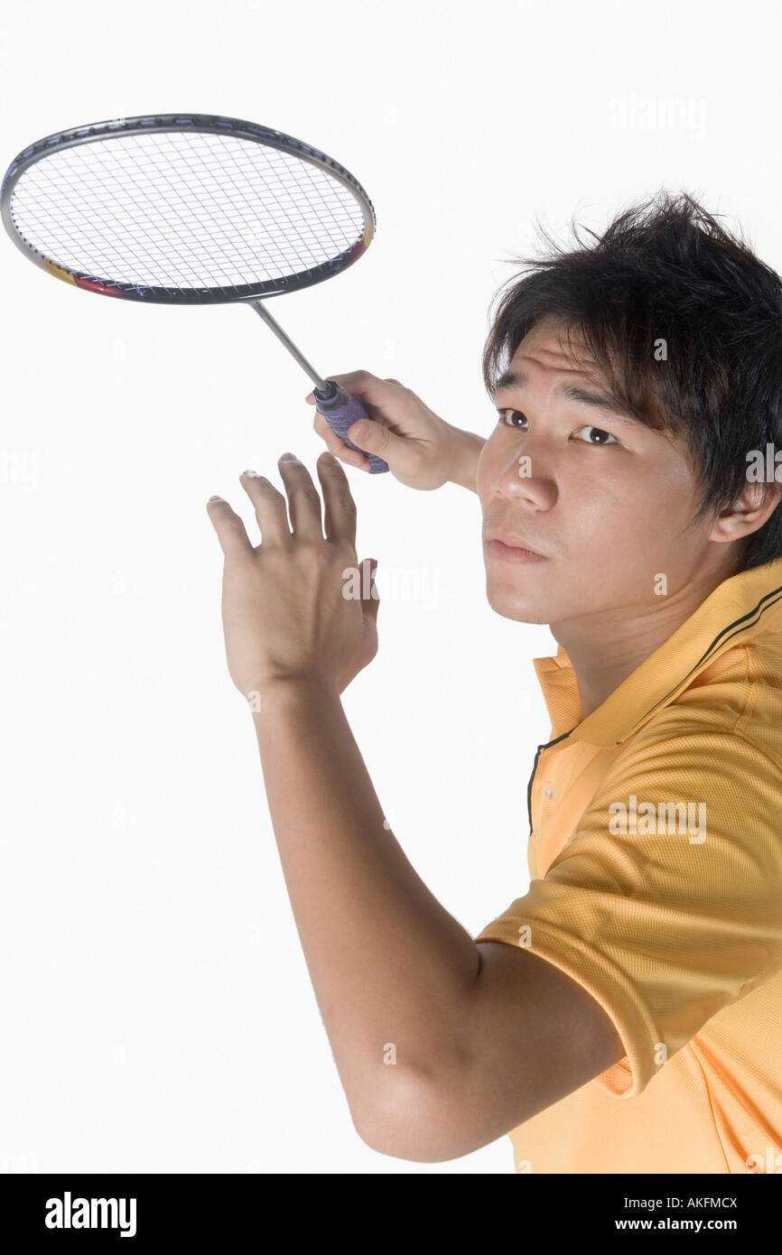 Close-up of a young man playing badminton Stock Photo - Alamy