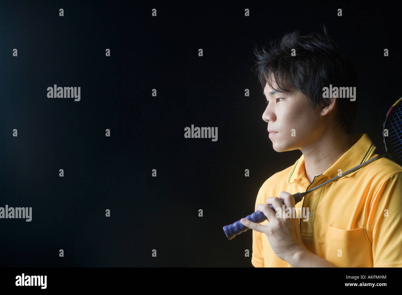 Close-up of a young man holding a badminton racket Stock Photo - Alamy