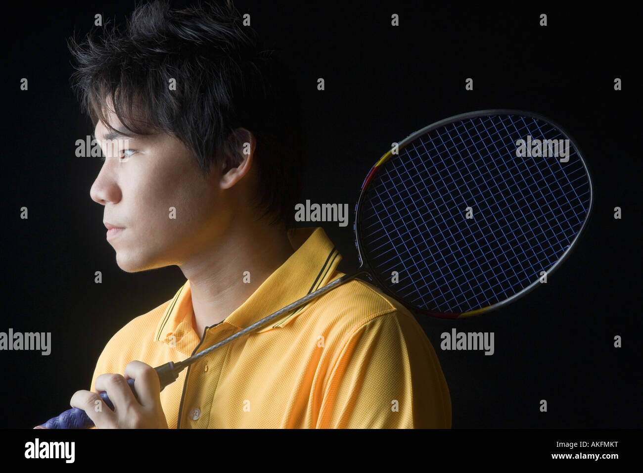 Close-up of a young man holding a badminton racket Stock Photo - Alamy