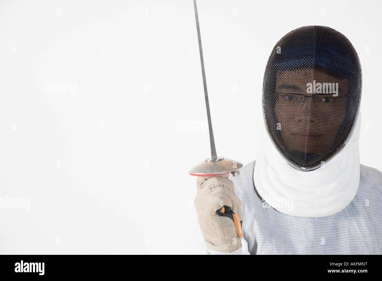 Portrait of a male fencer wearing fencing mask and holding a fencing ...