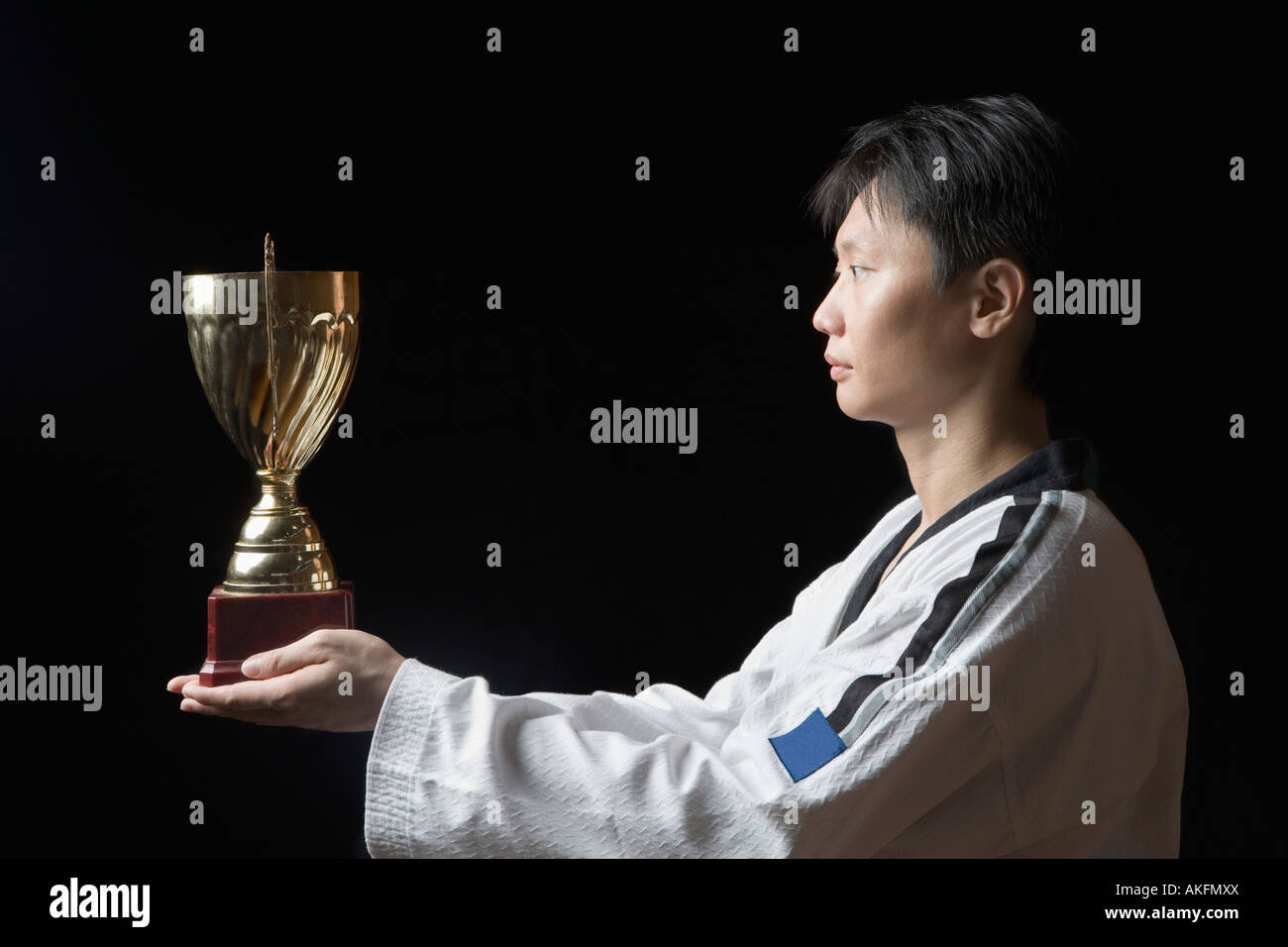 Side profile of a young man holding a trophy Stock Photo - Alamy