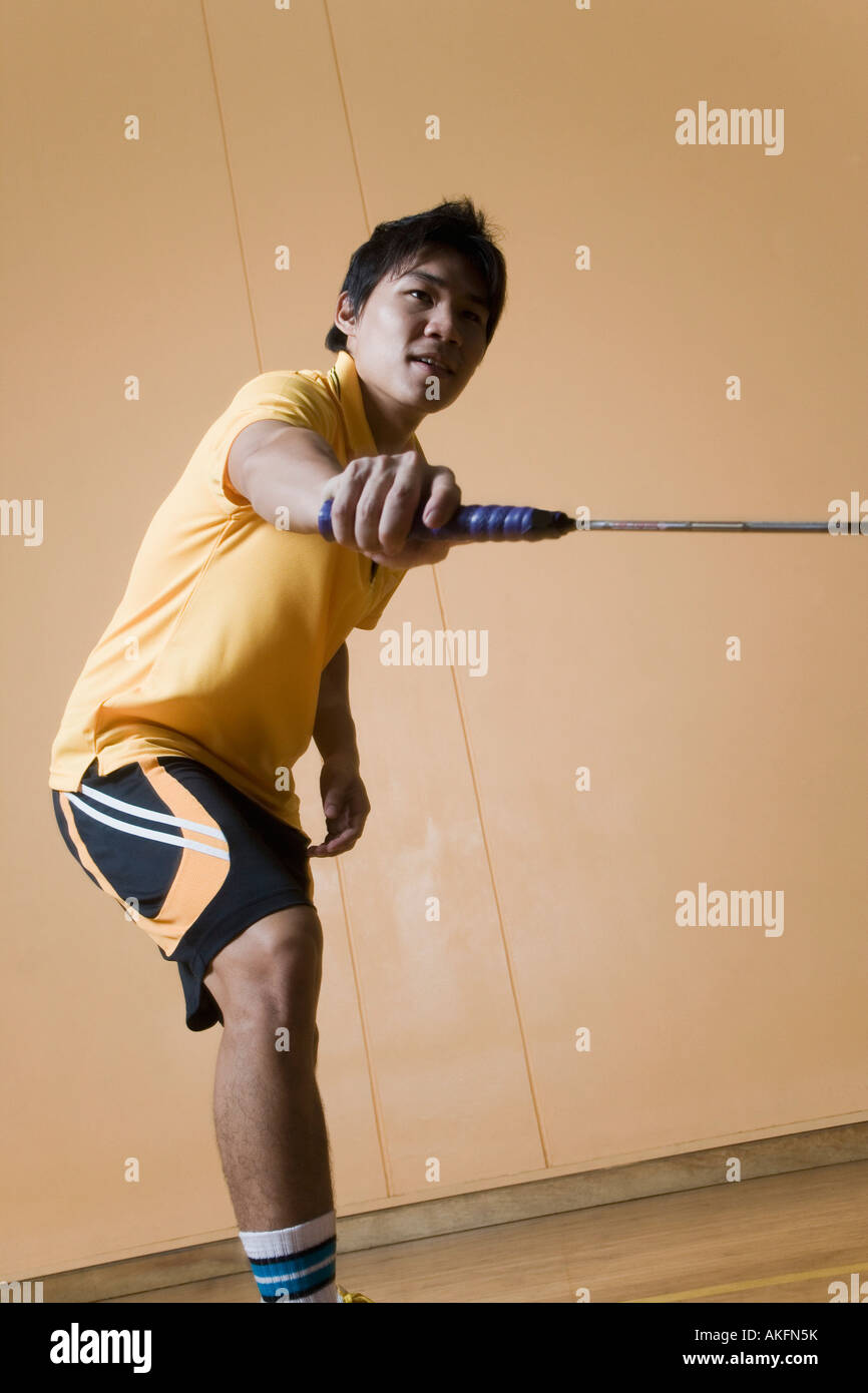 Side profile of a young man playing badminton Stock Photo - Alamy