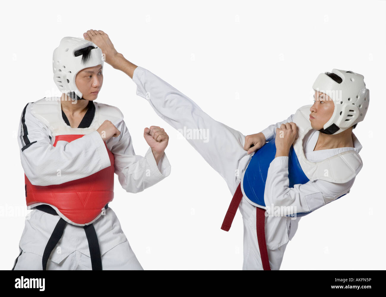 Close-up of a mid adult man practicing kickboxing with a young man ...
