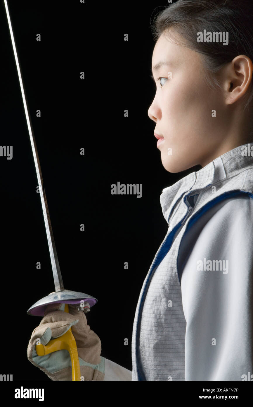 Side profile of a female fencer holding a fencing foil Stock Photo - Alamy