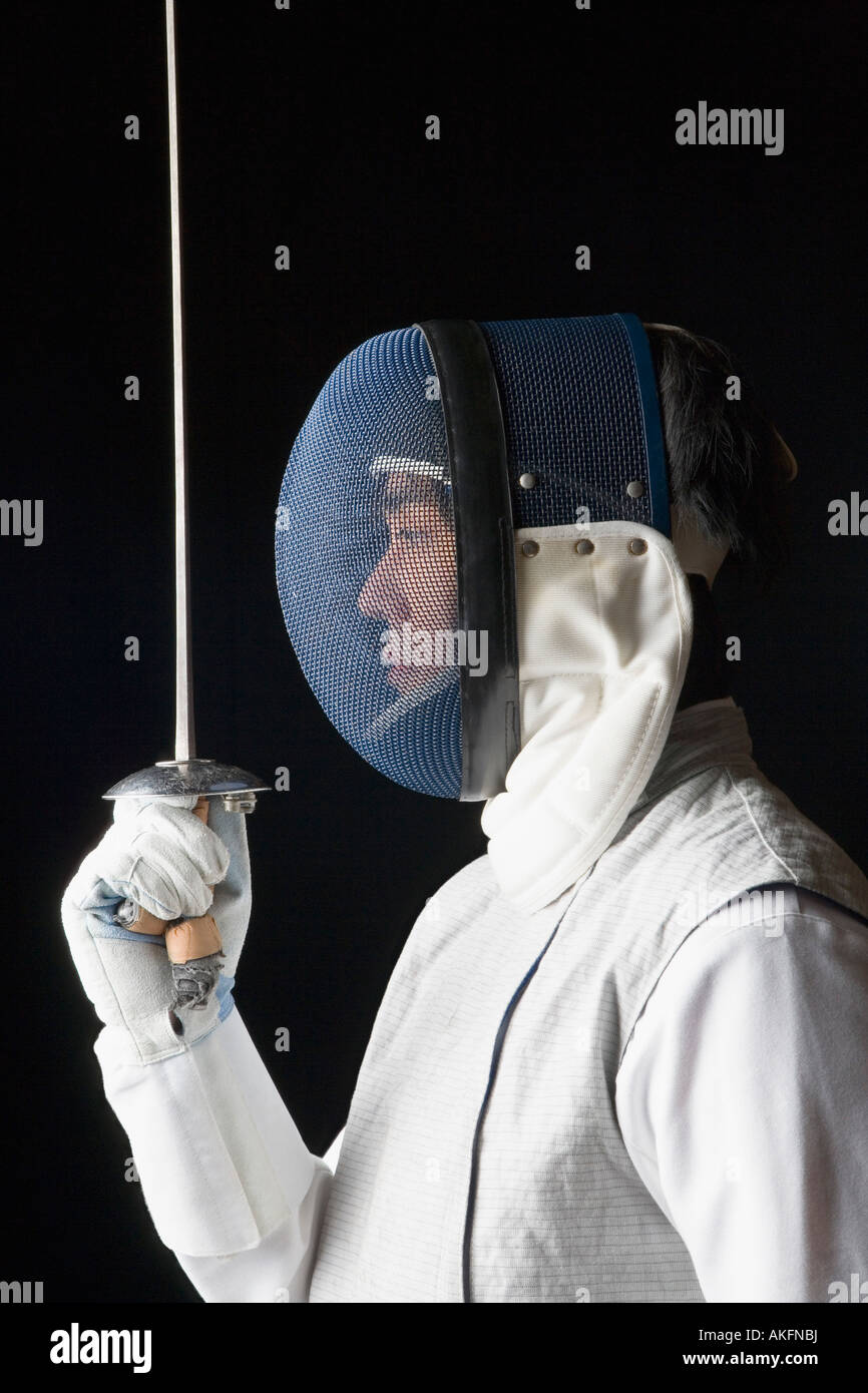 Side profile of a male fencer holding a fencing foil Stock Photo - Alamy