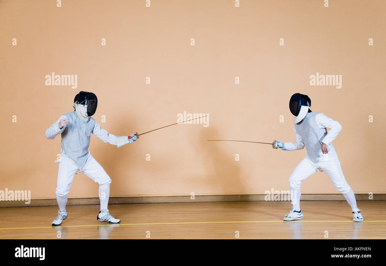 Two fencers fencing Stock Photo - Alamy