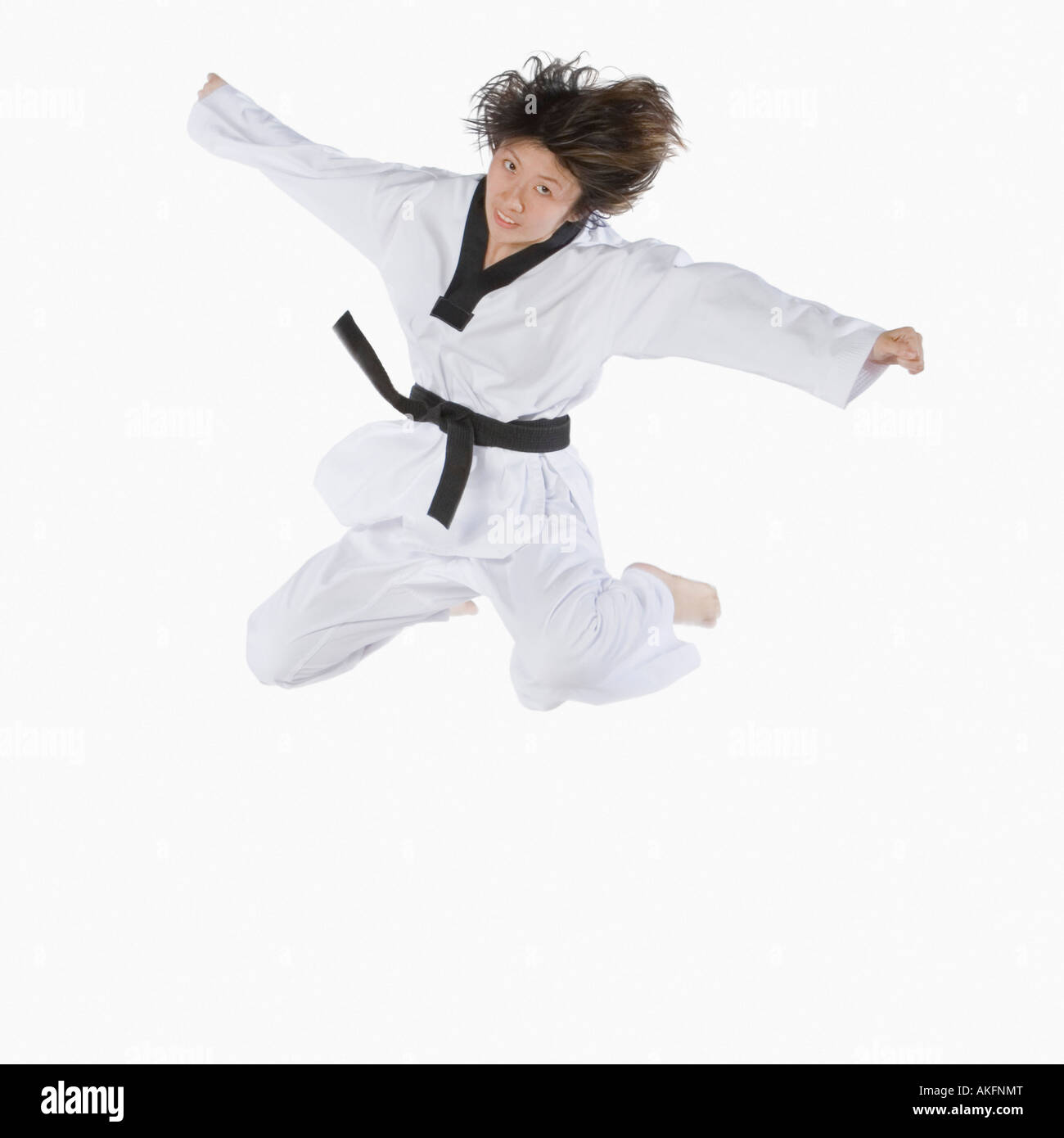 Portrait of a young woman jumping and practicing martial arts Stock ...