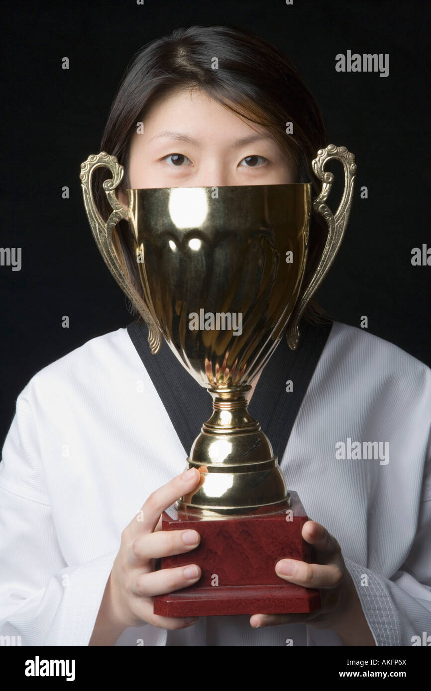Portrait of a young woman holding a trophy Stock Photo - Alamy