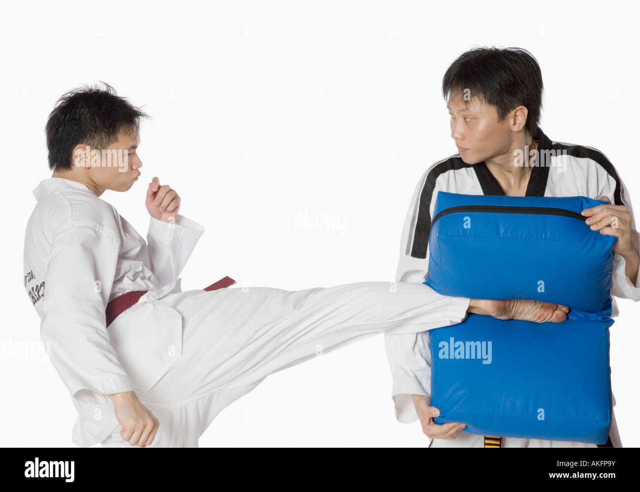 Male karate instructor teaching martial arts to a young man Stock Photo ...