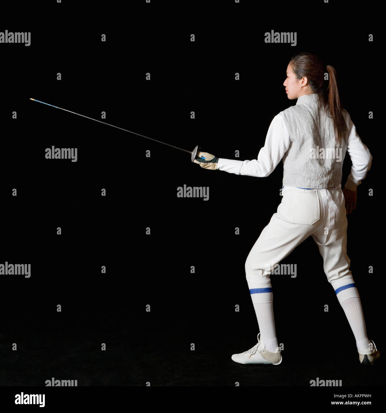 Rear view of a female fencer holding a fencing foil Stock Photo - Alamy
