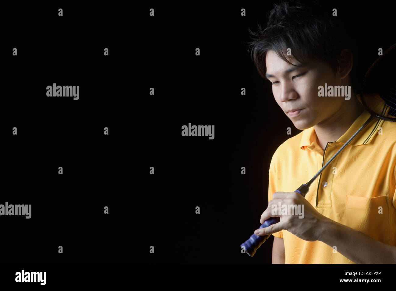 Close-up of a young man holding a badminton racket Stock Photo - Alamy
