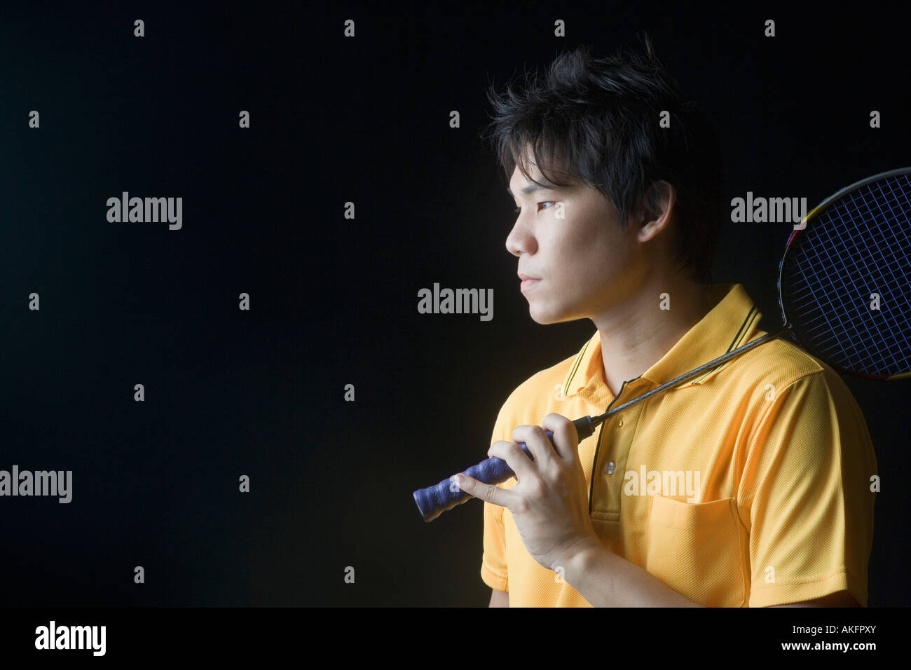 Close-up of a young man holding a badminton racket Stock Photo - Alamy