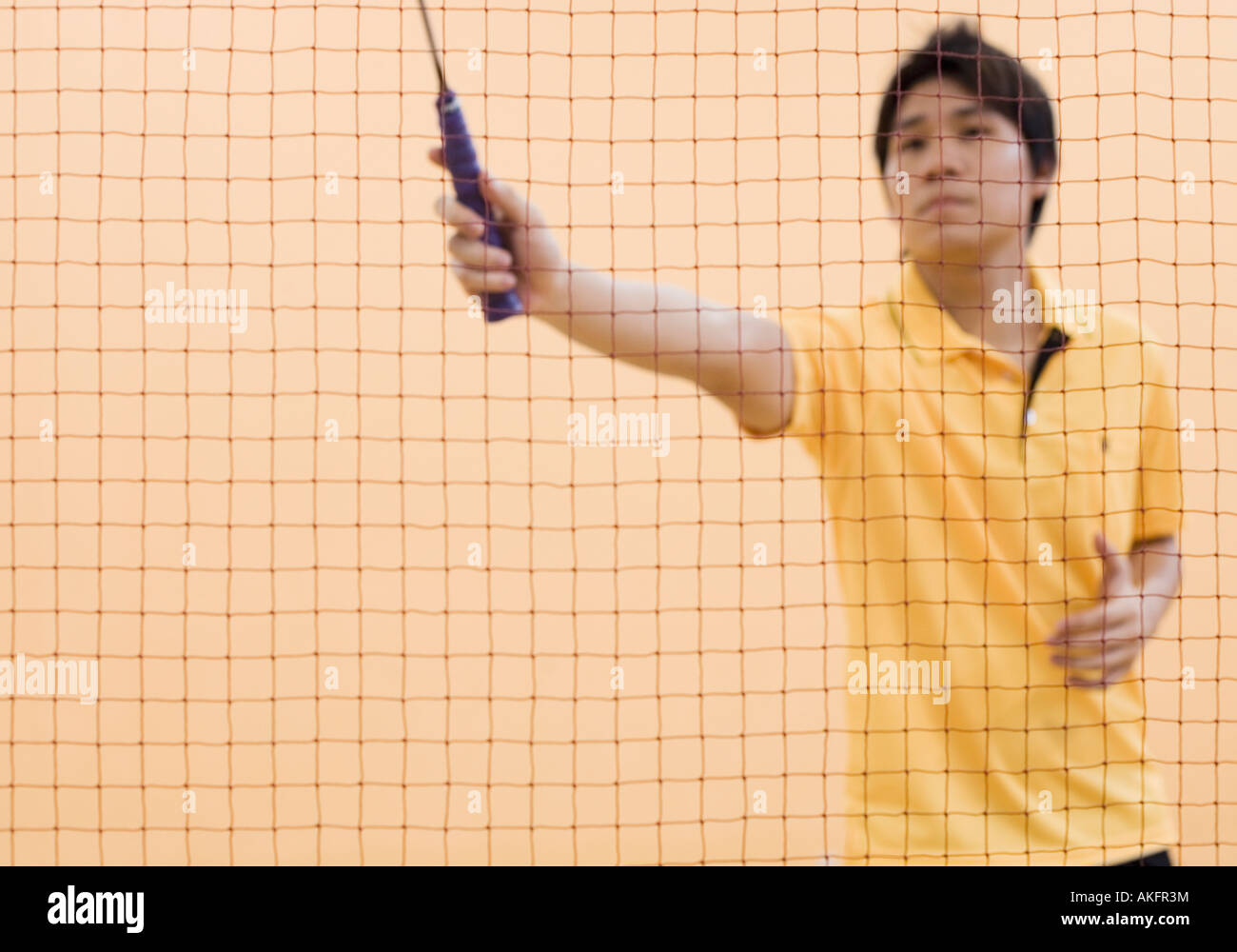 Young man playing badminton Stock Photo - Alamy