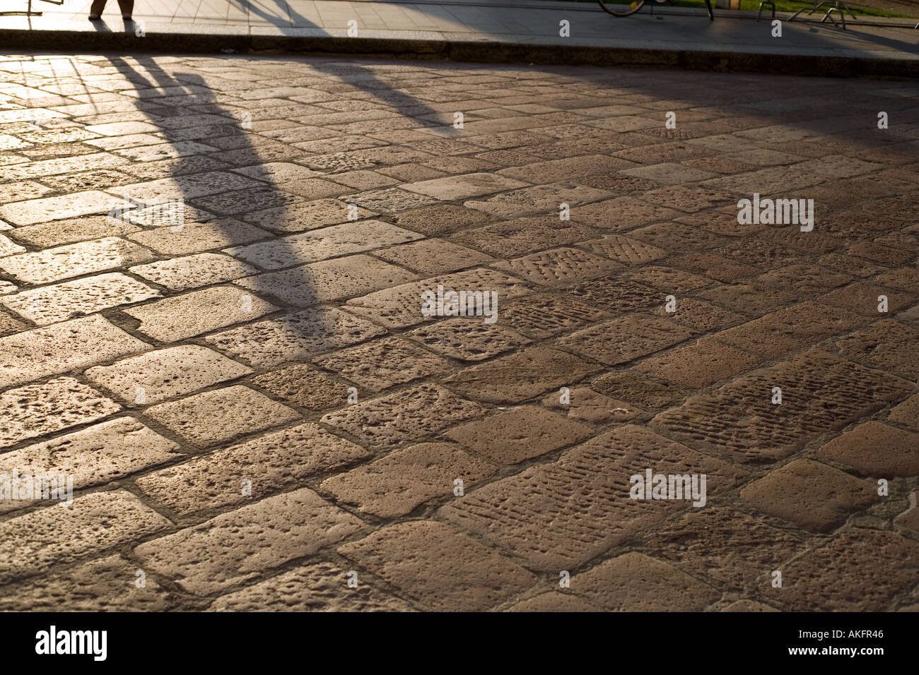 long shadows on stone pavement Stock Photo - Alamy