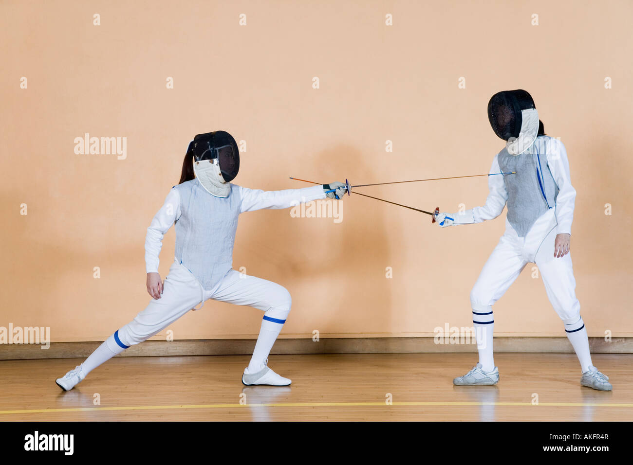 Two fencers fencing Stock Photo - Alamy