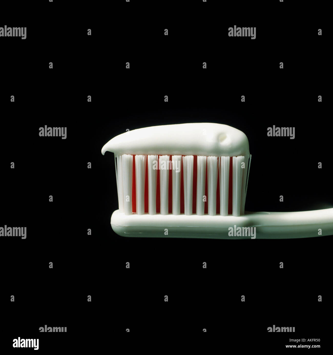toothpaste on toothbrush editorial use only Stock Photo - Alamy