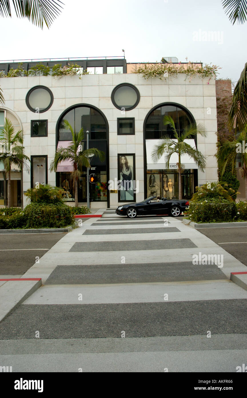 Luxury sports car driving by storefront on Rodeo Drive Beverly Hills ...