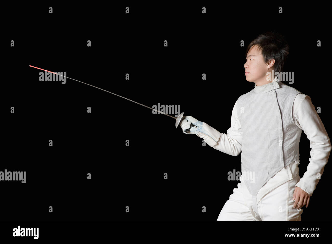 Male fencer holding a fencing foil Stock Photo - Alamy