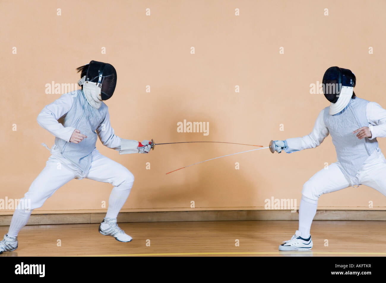 Two fencers fencing Stock Photo - Alamy