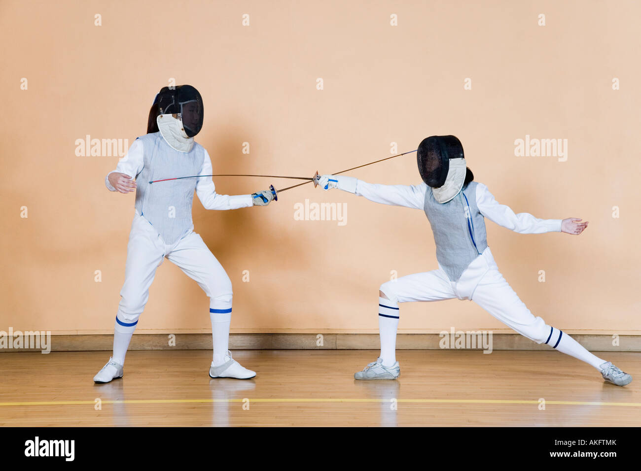 Two fencers fencing Stock Photo - Alamy