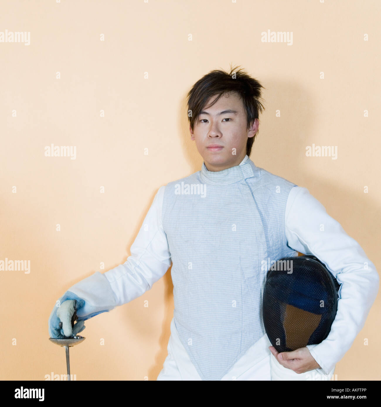 Portrait of a male fencer holding a sword and a fencing mask Stock ...