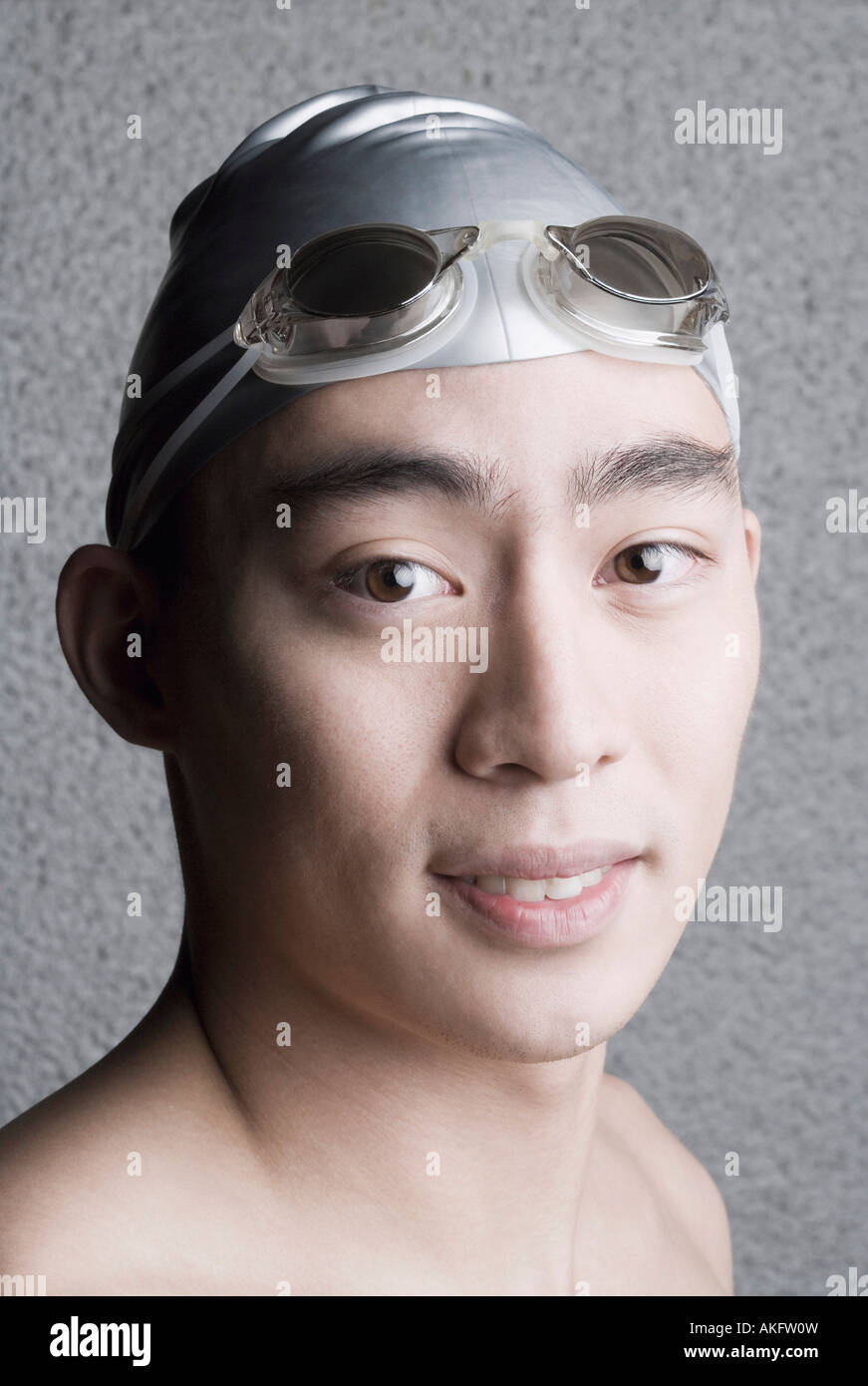 Portrait of a young man wearing swimming cap Stock Photo - Alamy