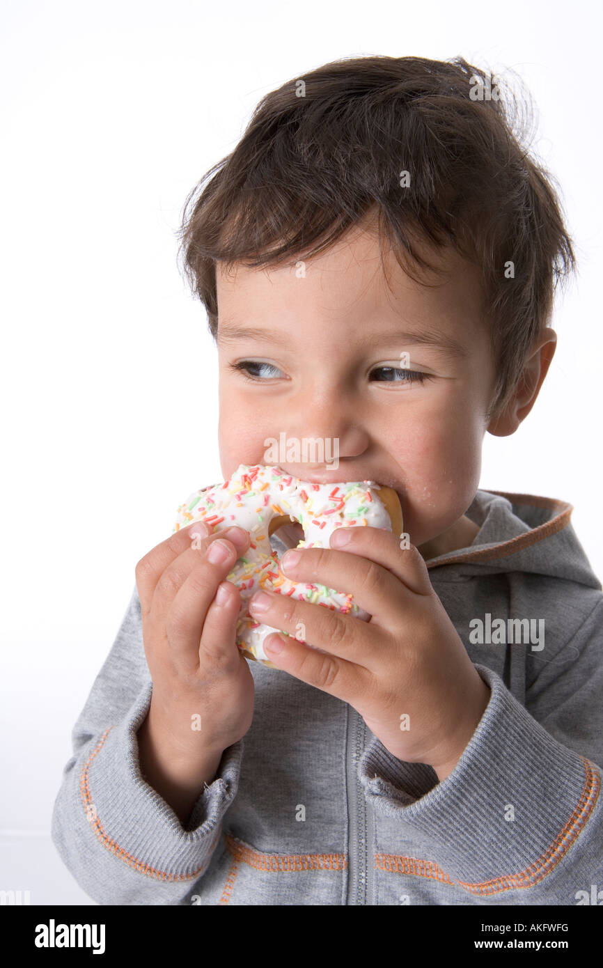 Little boy eating a donut Stock Photo - Alamy