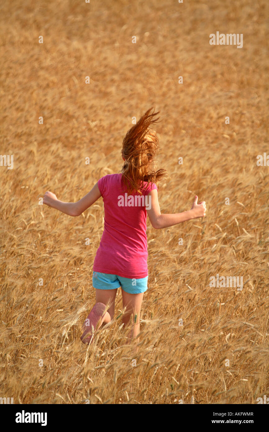 Girl running through wheat field hi-res stock photography and images ...