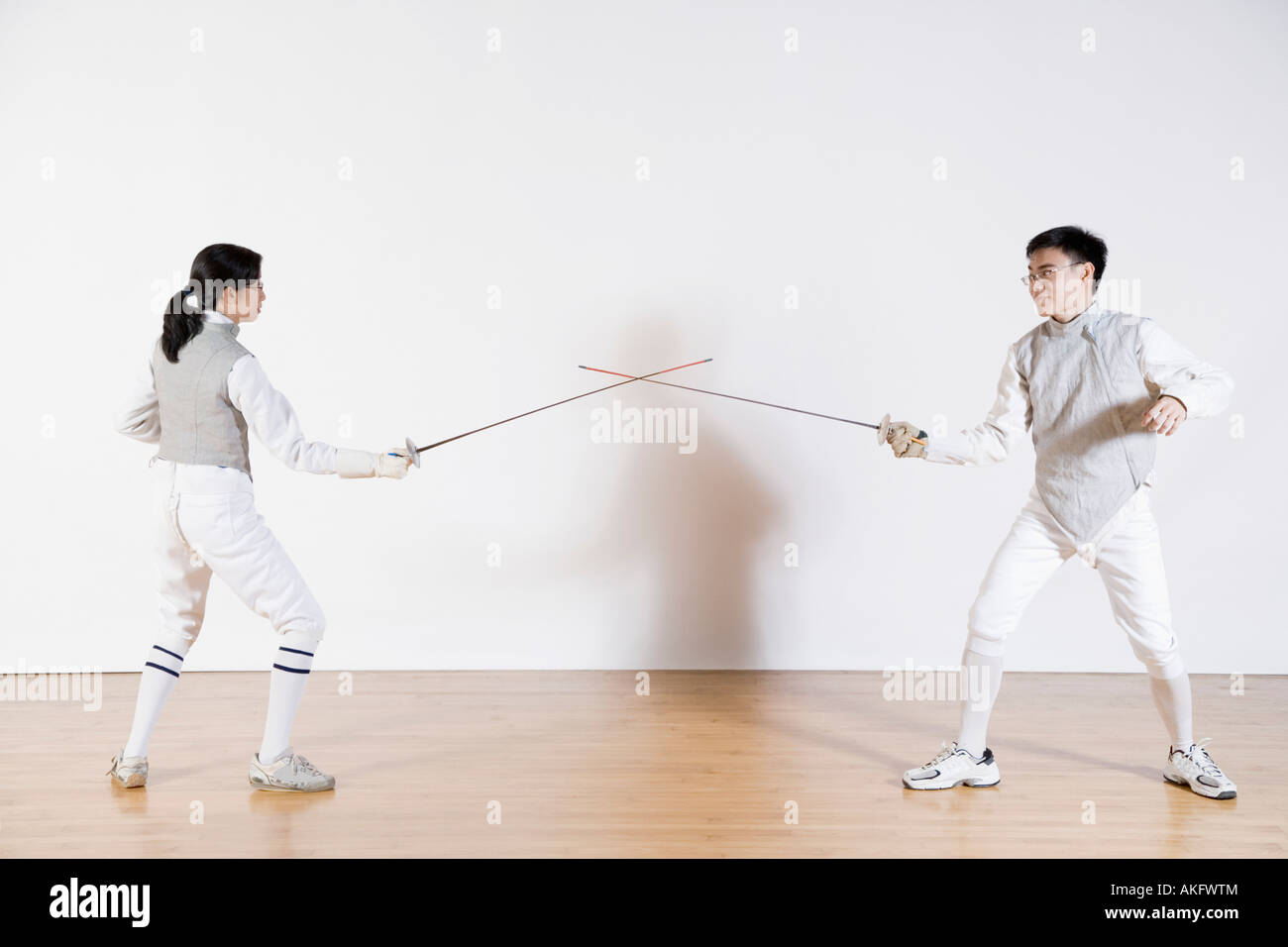 Male and a female fencer fencing Stock Photo - Alamy
