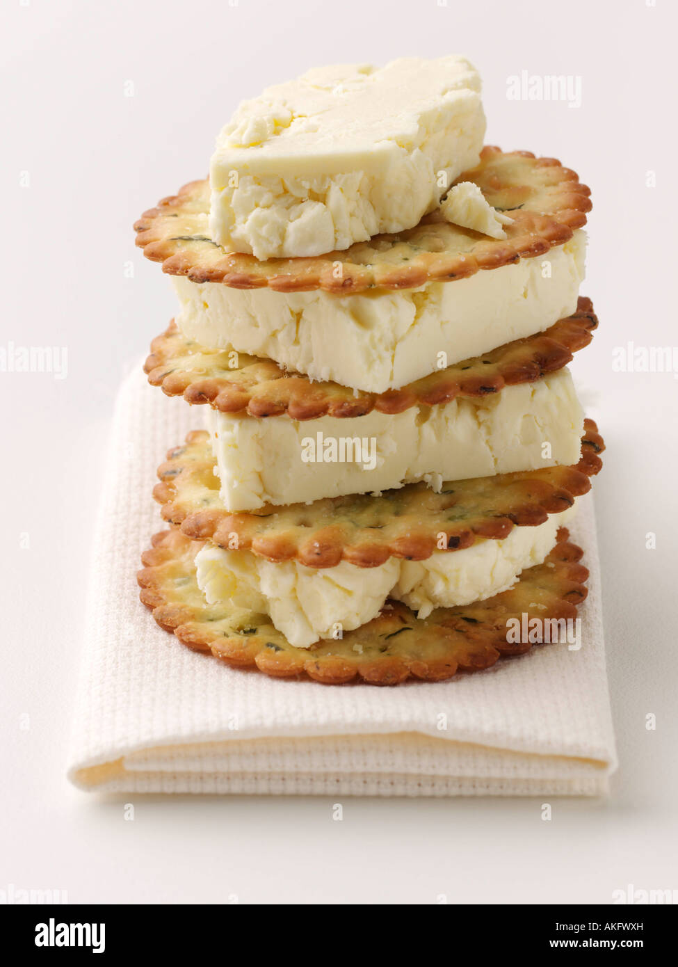 A stack of crackers and Lancashire cheese on a white background ...