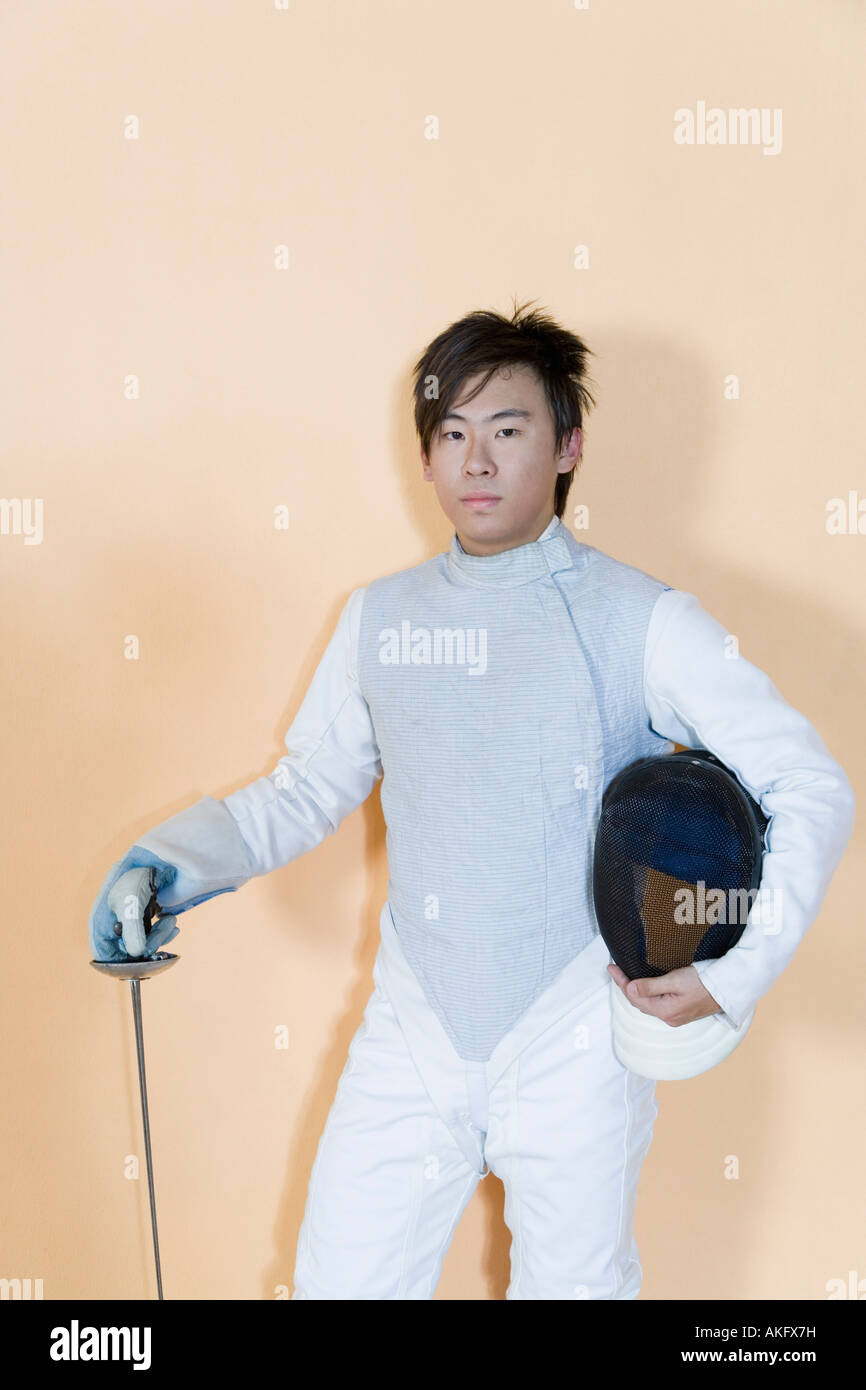 Portrait of a male fencer holding a sword and a fencing mask Stock ...